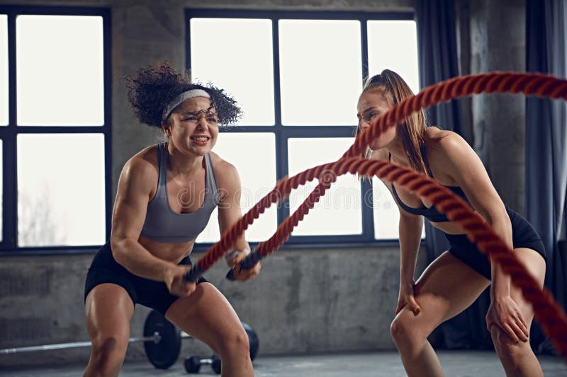 Strength Training. Dynamic Portrait of Strong Women Athletes Exercising ...