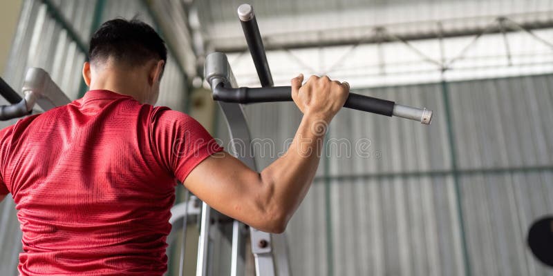 Strength Training. Man Performing Pull-ups at the Gym, Showcasing ...