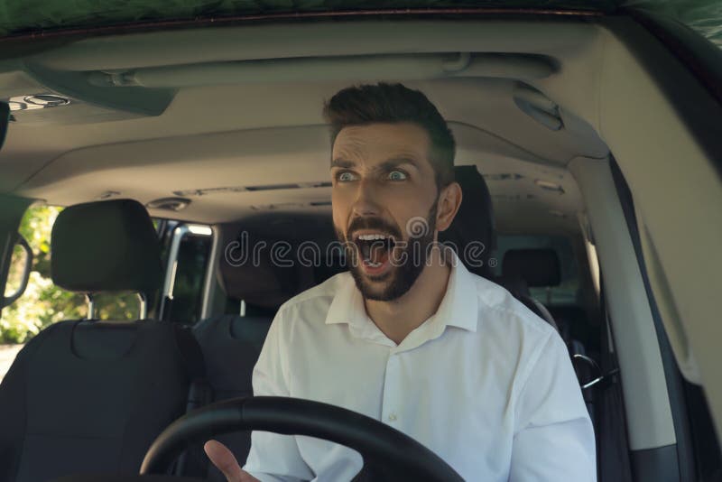 Stressed Angry Man in Driver`s Seat of Modern Car, View through ...