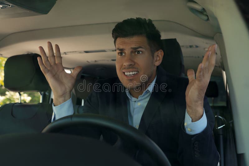 Stressed Angry Man in Driver`s Seat of Modern Car, View through ...
