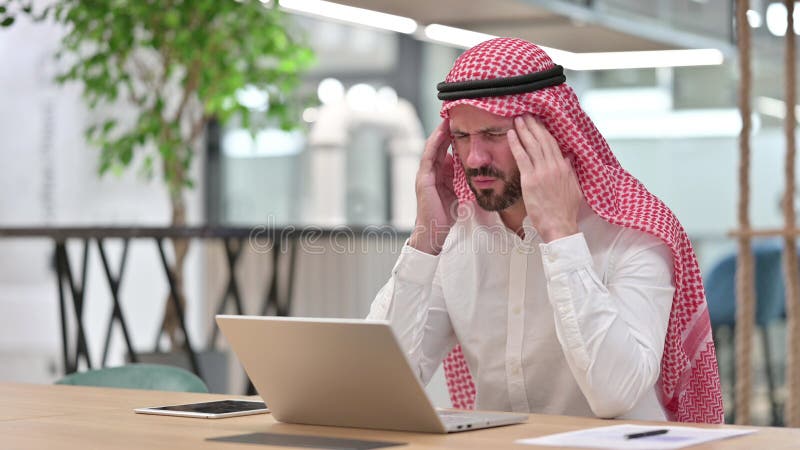 Stressed Arab Employee with Laptop and Documents Having Problem with ...