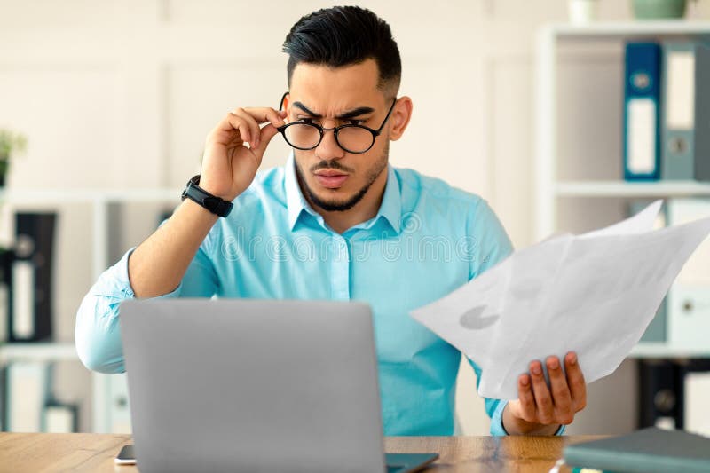 Stressed Arab Employee with Laptop and Documents Having Problem with ...