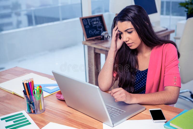 Stressed Man on Laptop Desk Surrounded by Files Phones Tablets in ...