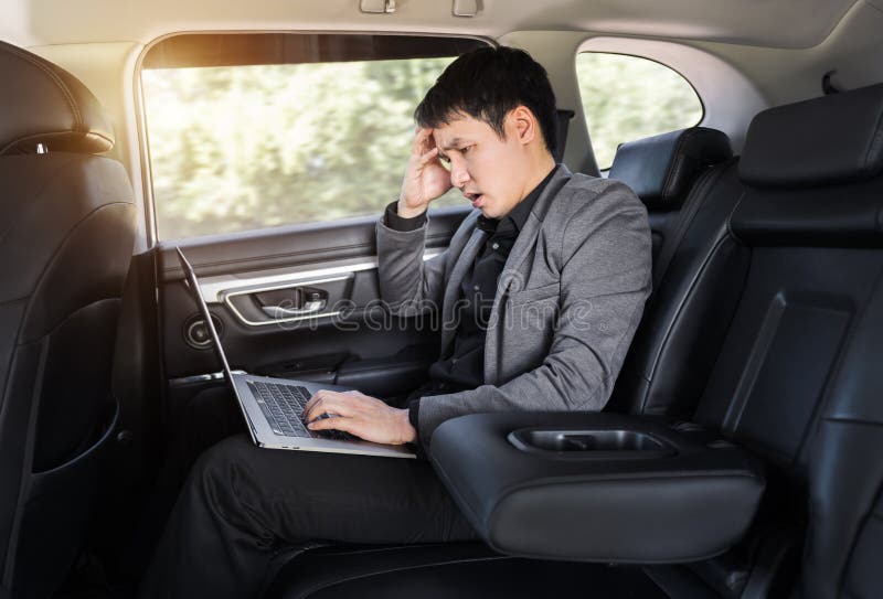 Stressed Business Man Using Laptop Computer while Sitting in the Back ...