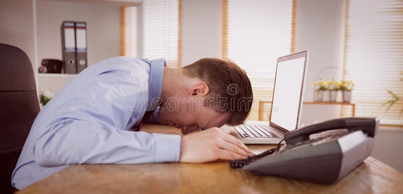 Stressed Man on Laptop Desk Surrounded by Files Phones Tablets in ...