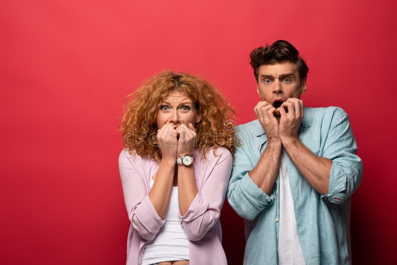 Stressed Couple Gesturing in Casual Clothes Isolated on Red Stock Photo ...