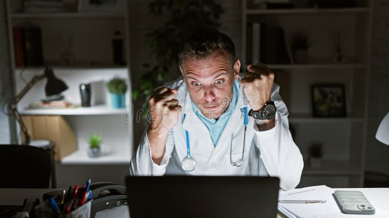 Stressed Doctor in Clinic Office Working Late with Computer and ...