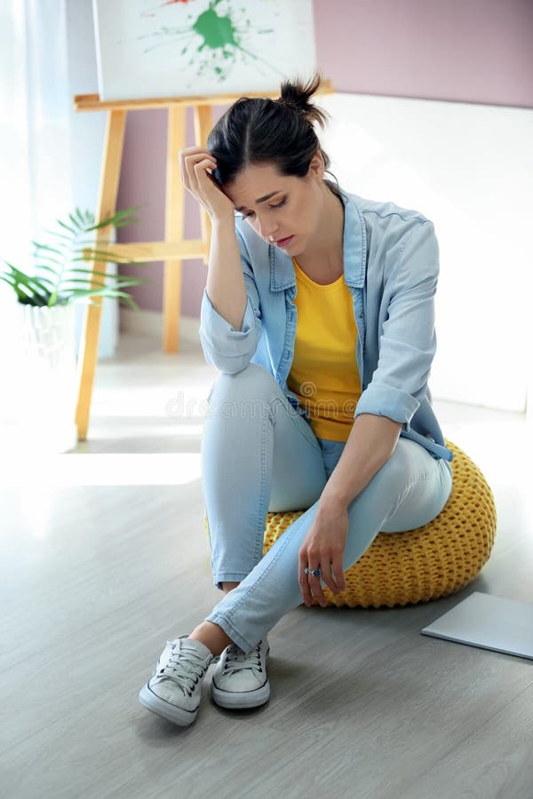 Stressed Female Painter in Studio Stock Photo - Image of ottoman, pouf ...