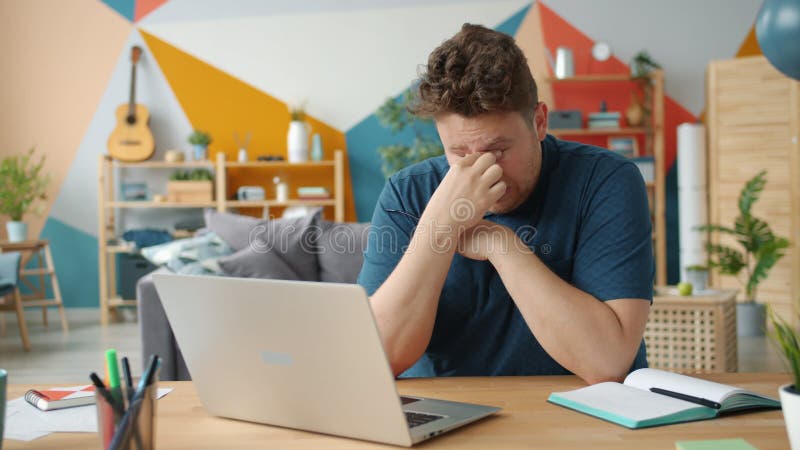 Stressed Guy Freelance Worker is Using Laptop Typing Feeling Tired and ...