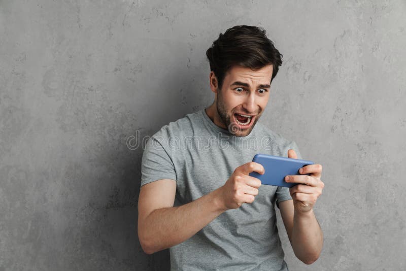 Stressed Handsome Guy Screaming while Playing Online Game on Cellphone ...