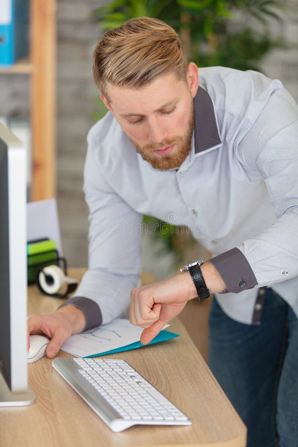 Stressed Man Using Computer Looks at Wristwatch Stock Photo - Image of ...