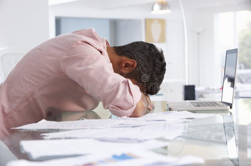 Stressed Man Working at Desk in Busy Creative Office Stock Image ...