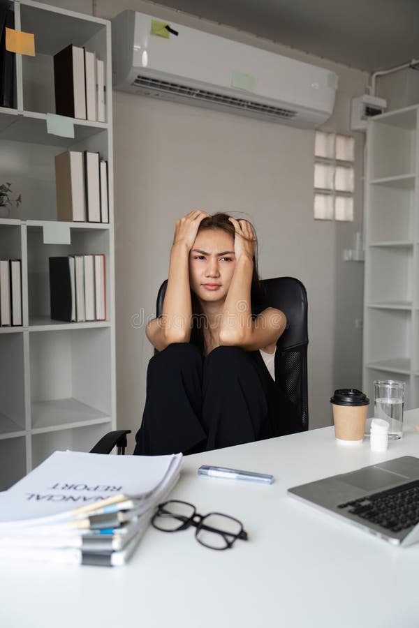 Stressed Office Worker Sitting at Desk with Documents and Laptop in ...