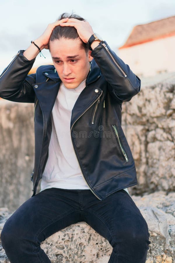 Stressed and Sad Man in Jacket Sitting Outdoors Holding Head with Hand ...