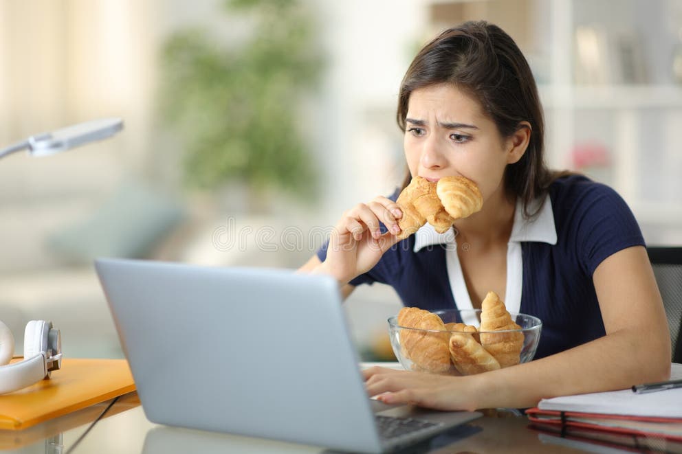 Stressed Student Eating a Lot of Bakery Checking Laptop Stock Photo ...