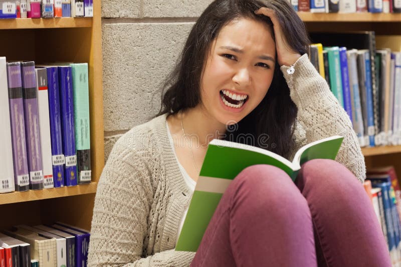Stressed Student Reading in a Library Stock Image - Image of library ...