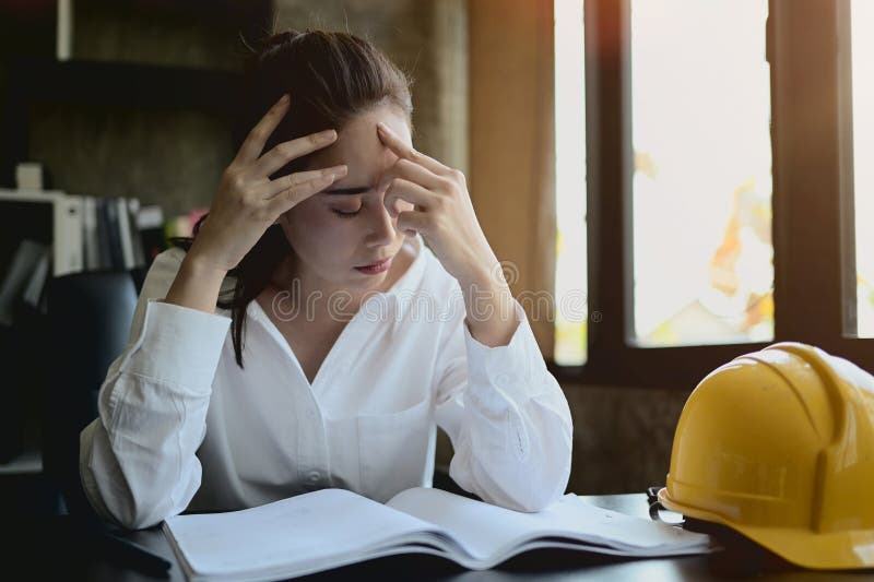 A Stressed, Tired Asian Female Architect or Engineer Boss Sits at Her ...