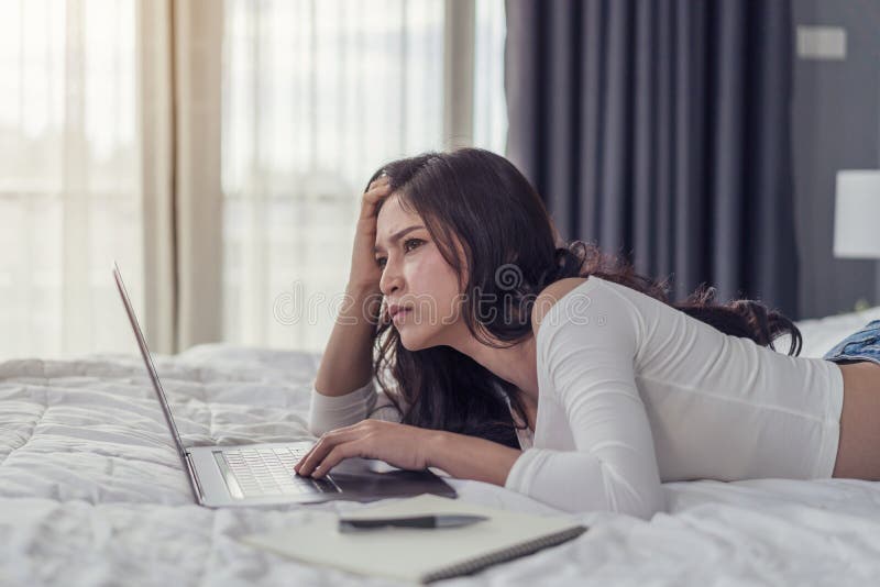 Stressed Woman Using Laptop Computer on Bed Stock Image - Image of ...