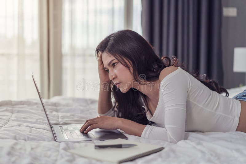 Stressed Woman Using Laptop Computer on Bed Stock Image - Image of ...