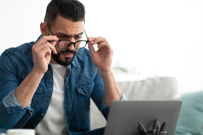 Stressed Young Arab Man Using Laptop, Having Difficulty Performing Work ...