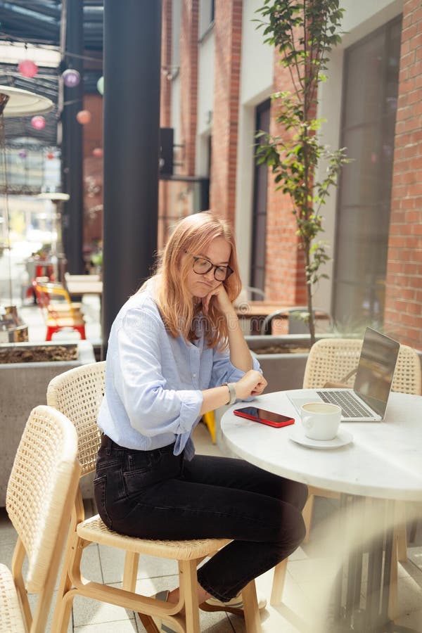 Stressed Young Blonde Woman Using Laptop at Cafe, Sitting at Table with ...