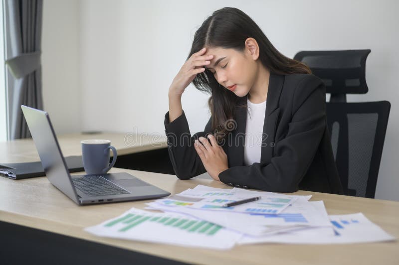 Stressed Young Business Woman Working on Laptop with Documents in ...