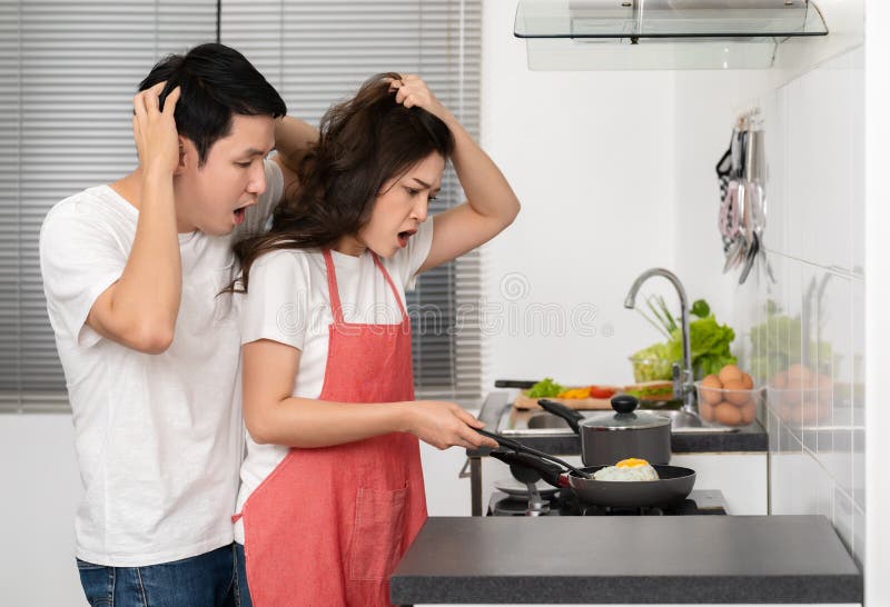 Stressed Couple Cooking and Preparing Food in the Kitchen at Home Stock ...