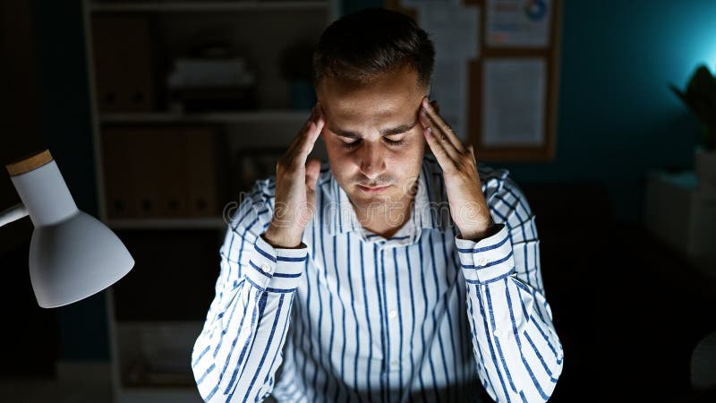 Stressed Young Hispanic Man in Office Touching Temples with Eyes Closed ...