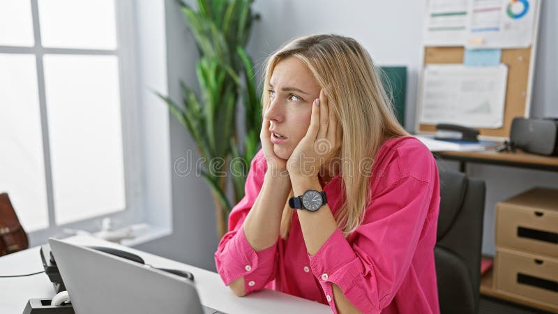 A Stressed Young Woman at Her Workplace Showing Frustration in an ...