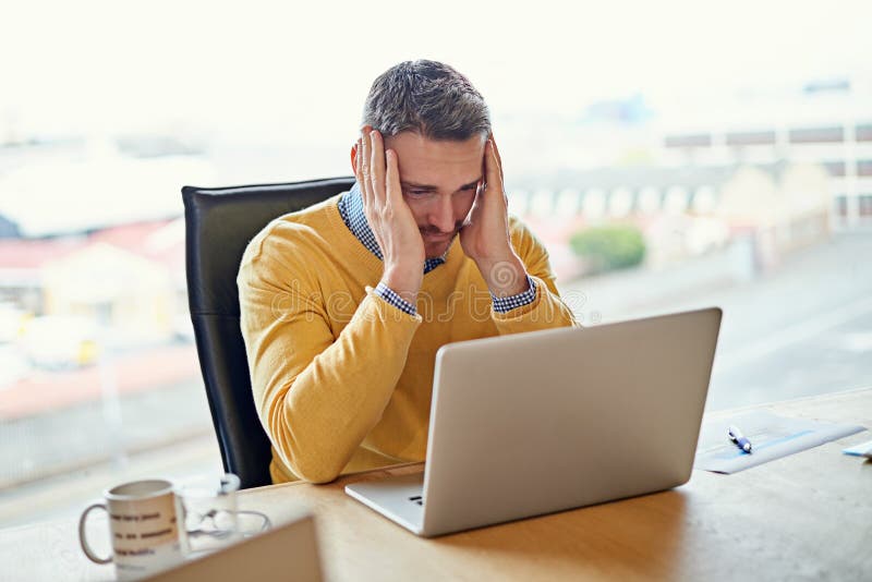Stressful Day at the Office. Shot of a Businessman Working on His ... Stressful Day at the Office. Shot of a Businessman Working on His ...