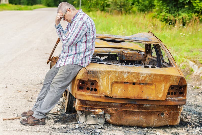 Stressful Man On Burned Down Car Wreck On The Side Of The Road Stock