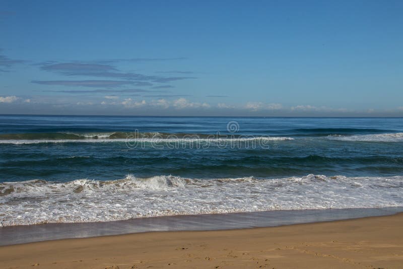 Stretch of Beach with Blue Sky and Clouds on Horizon Stock Photo ...