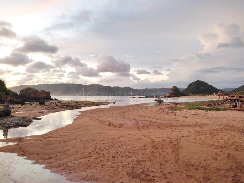 Stretch of Beach Sand with a River Flowing Towards the Sea and the ...