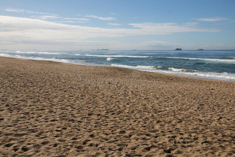 Stretch of Beach with Ships Anchored on Horizon Stock Photo - Image of ...