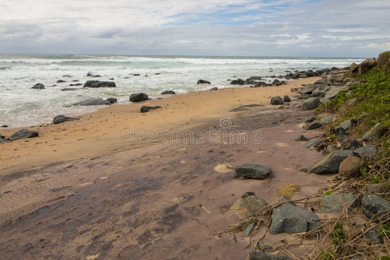 Stretch of Wet Beach and Rocks with Ebbing Tide Stock Photo - Image of ...