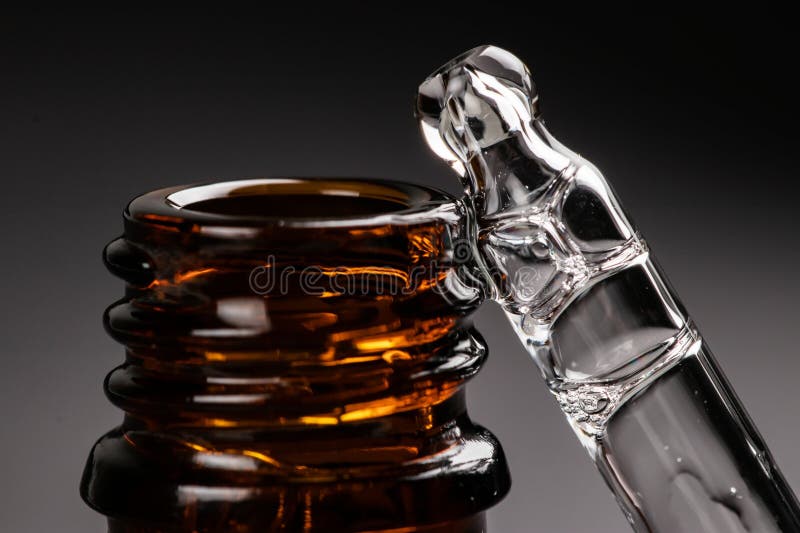 Stretched Drop Dripping from a Cosmetic Pipette Isolated on a White ...