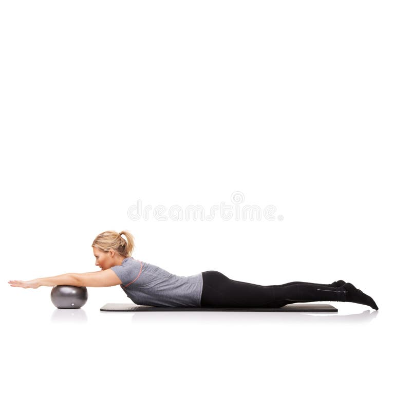 Stretched Out on Her Exercise Mat. a Young Woman Using an Exercise Ball ...