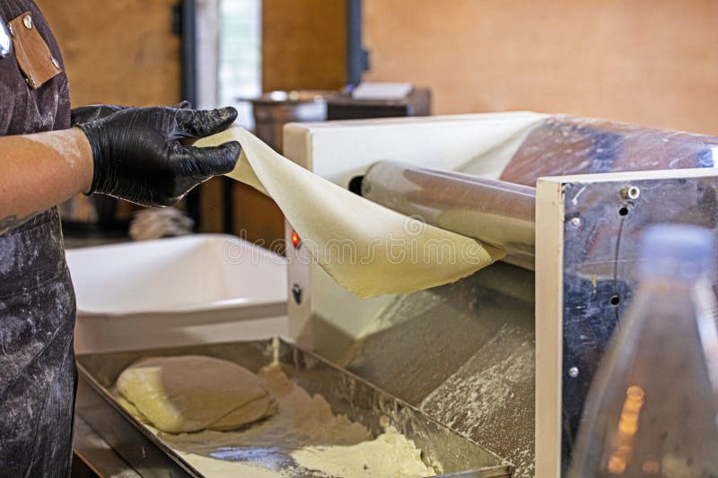 Stretching Dough for Chebureks with a Special Machine. Stock Photo ...