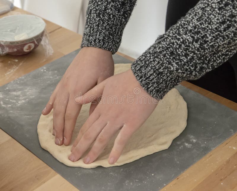 Stretching dough for pizza stock photo. Image of restaurant - 142576342
