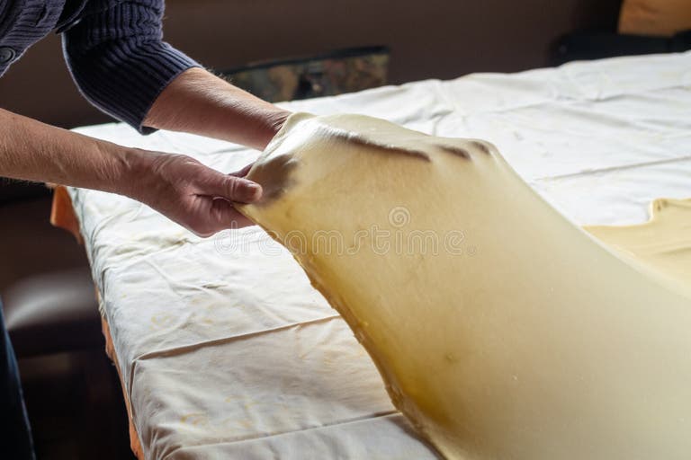 Stretching Dough for Strudel Over a Kitchen Table Stock Photo - Image ...