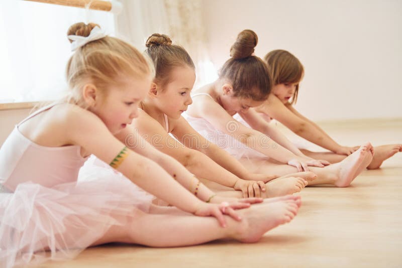 Stretching Exercises. Little Ballerinas Preparing for Performance Stock ...
