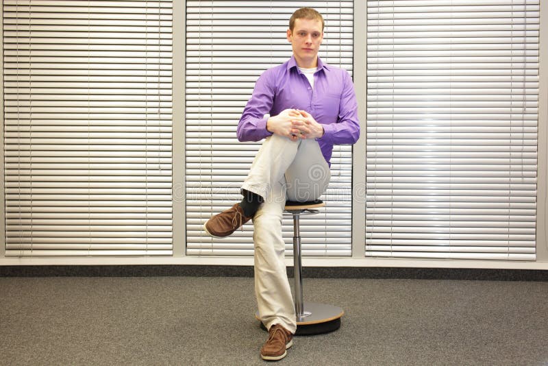 Stretching Legs in Office - Man Sitting on Pneumatic Stool Exercising ...