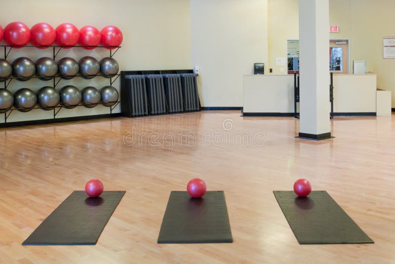 Stretching Mats and Exercise Balls in Gym Stock Photo - Image of ...
