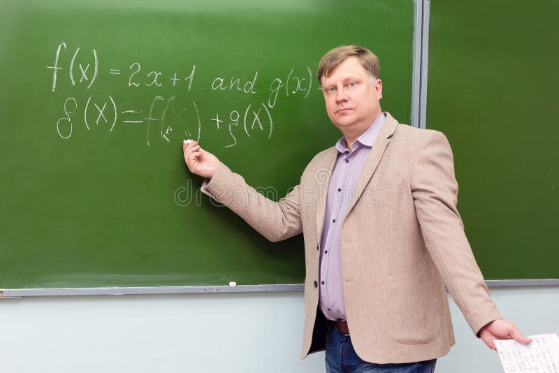 A Strict Math Teacher at the Blackboard Explains Stock Photo - Image of ...