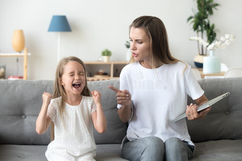Strict Mom Scolding Ill Behaved Daughter Screaming Loud At Home Stock