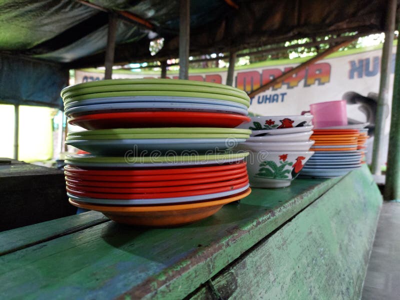 The Strict Pile of Color Plates Lies on a Table in Food Stalls Stock ...