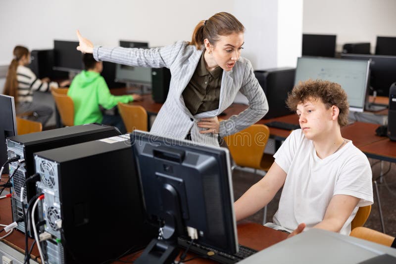 Strict Teacher Reprimanding Negligent Teenage Student in Computer Class ... Strict Teacher Reprimanding Negligent Teenage Student in Computer Class ...