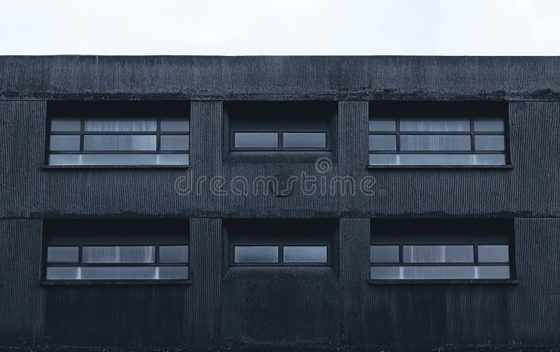 A Striking Black Building Features a Prominent Clock on Its Facade ...
