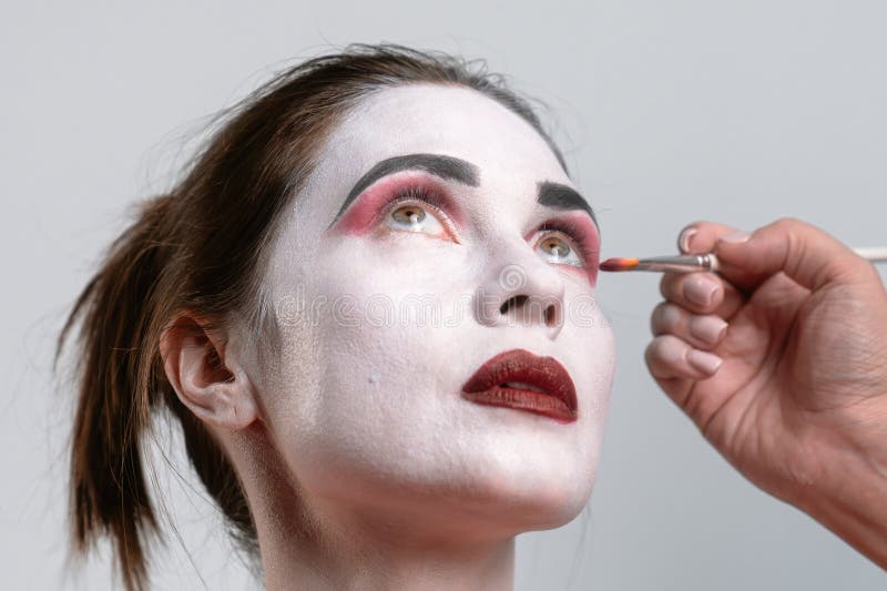 Intricate Face Painting with Bold Makeup Application Stock Photo ...