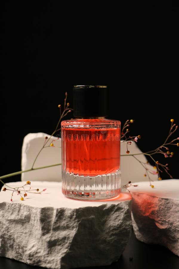 Elegant Red Perfume Bottle on White Stone with Floral Accents Stock ...